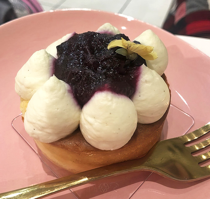 Blueberry cheesecake crowned with dollops of cream and fresh berries &ndash; proof that sometimes the most beautiful things in life are also the most delicious.