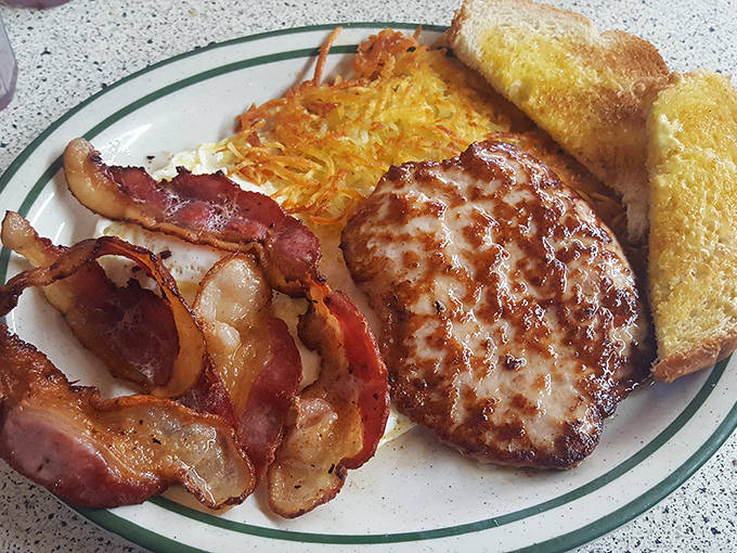 Ham steak charred just right, eggs with picture-perfect yolks, and hash browns with that ideal crisp-to-tender ratio that chain restaurants can only dream about.