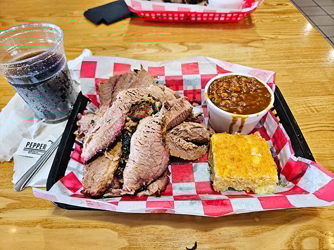 This brisket plate showcases the beautiful bark and perfect smoke ring that only comes from patience, skill, and serious dedication to the craft.