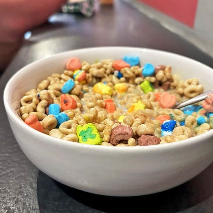 Childhood nostalgia in a bowl: Lucky Charms marshmallows float among colorful cereal pieces, proving adulthood doesn't mean abandoning joy.