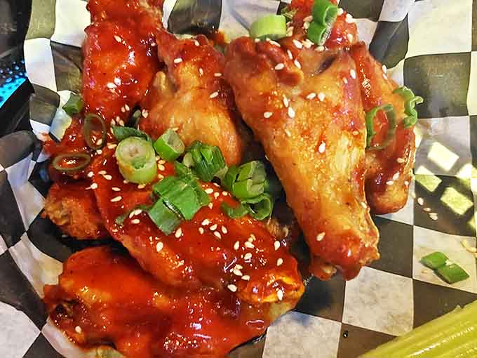 These aren't your average wings &ndash; glazed with a sweet-spicy sauce and garnished with green onions and sesame seeds.