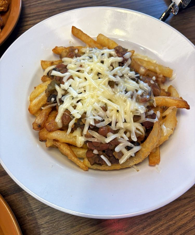 Chili cheese fries that transform a side dish into the main event &ndash; a mountain of potato, cheese, and chili that demands to be conquered.