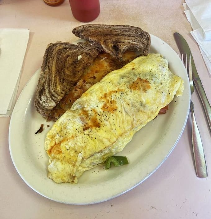 The chorizo omelet arrives like a golden pillow stuffed with spicy sausage and melted cheese&mdash;breakfast architecture at its finest.