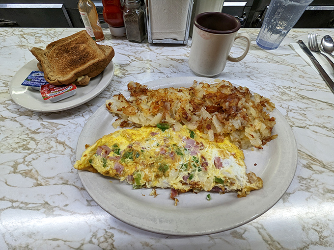 The American breakfast trifecta: perfectly scrambled eggs, crispy bacon, and golden hash browns &ndash; simple perfection that needs no reinvention.