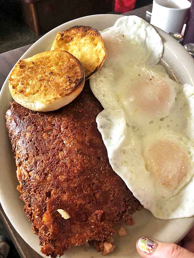 The Corned Beef Hash arrives like a colorful mosaic of flavors &ndash; tender meat, crispy potatoes, and vibrant peppers crowned with perfectly scrambled eggs.