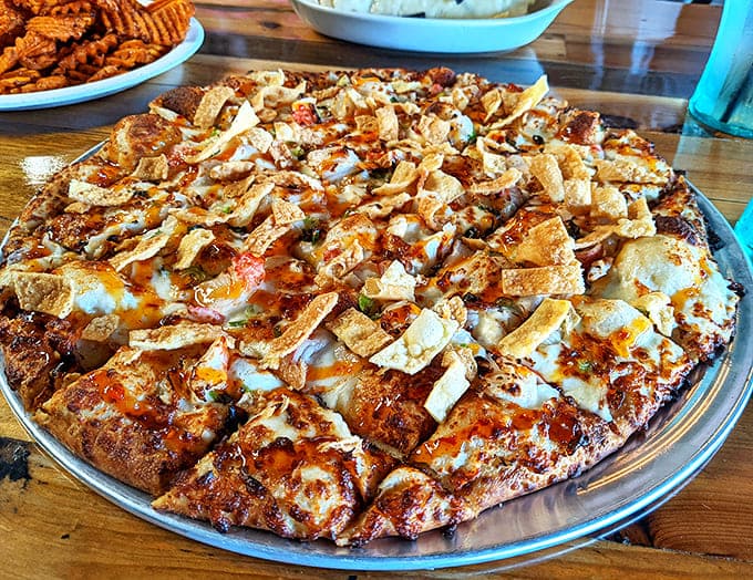 Crab Rangoon reimagined as pizza? It's culinary fusion that shouldn't work but absolutely does, topped with crispy wonton strips.