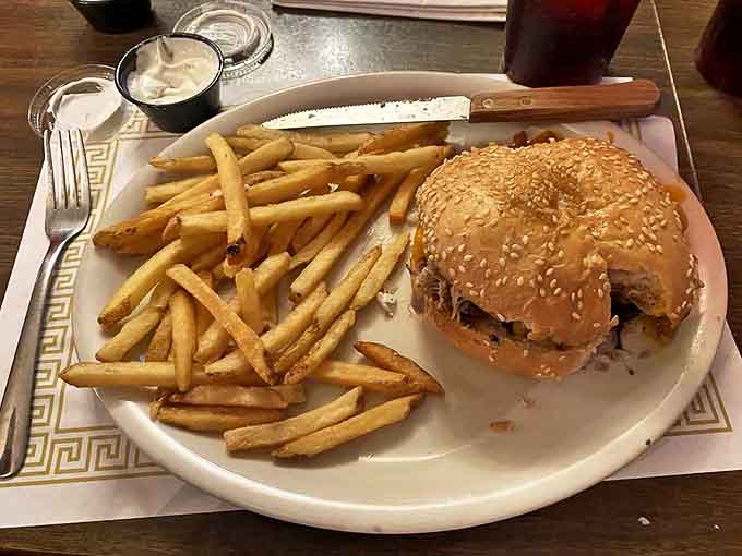 The Dixie Burger brings Southern charm to Michigan, topped with tangy coleslaw and served with crispy fries that disappear one "just one more" at a time.