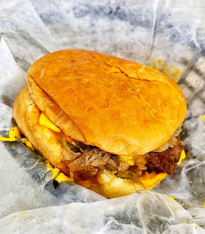 That melted cheese cascading over a juicy double burger is basically edible happiness wrapped in wax paper.