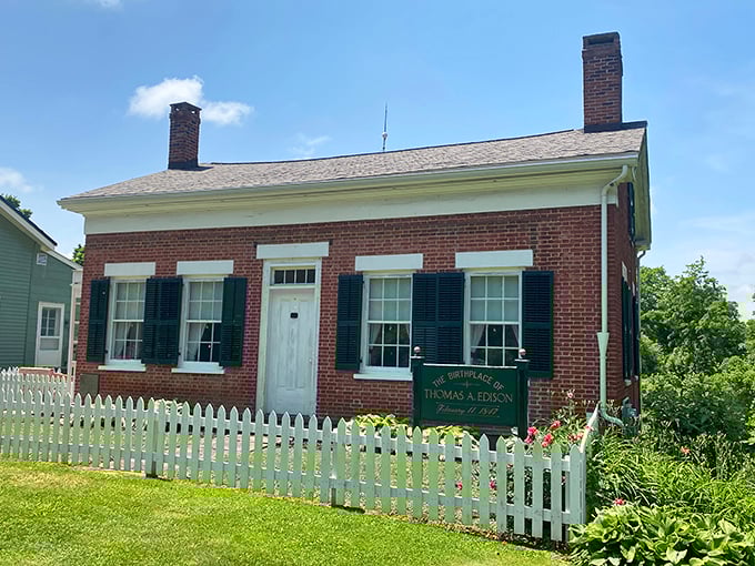 The Edison Birthplace stands proudly behind its white picket fence, a humble brick home that launched an extraordinary legacy.
