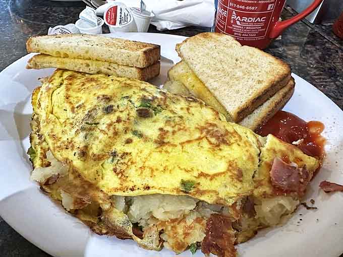 The Farmer's Omelette arrives loaded with enough ingredients to fuel a day of actual farming, or at least a solid afternoon of couch sitting.
