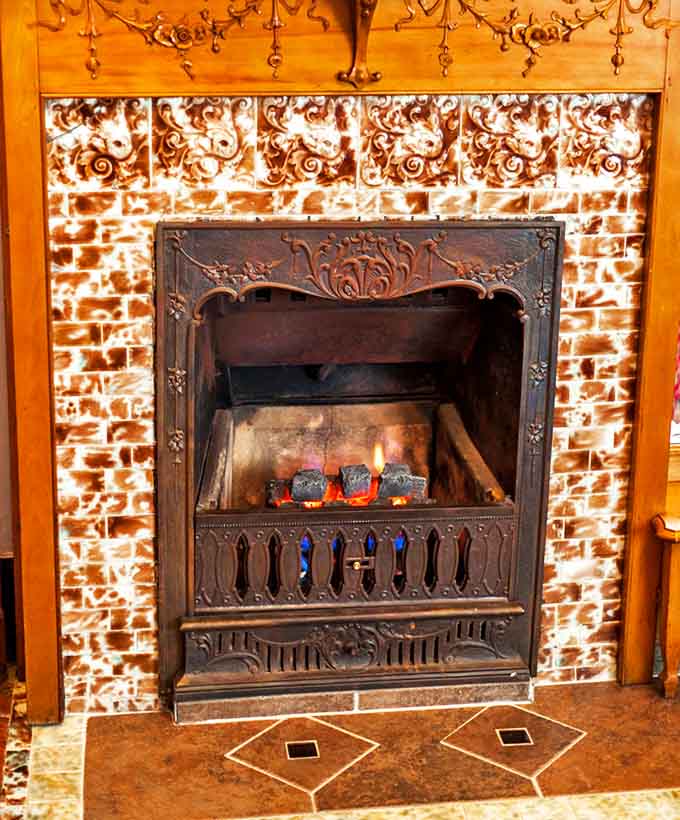 Fireplace: The ornate fireplace combines Victorian craftsmanship with the timeless comfort of a crackling fire&mdash;instant stress relief in architectural form.