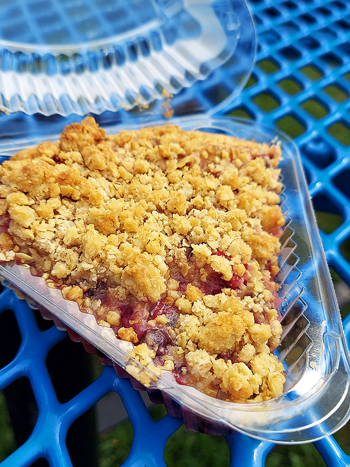 Enjoying a delicious slice of Betty's famous Great Lakes Pie, packed with mixed berries and topped with a buttery, irresistible, golden crumble.