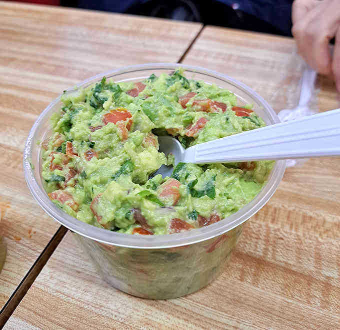 Fresh guacamole that's chunky, creamy, and studded with tomato and cilantro &ndash; the kind that makes store-bought versions weep with inadequacy.