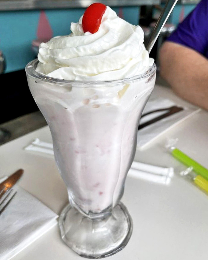 A classic strawberry milkshake topped with a cloud of whipped cream and a cherry &ndash; simple perfection that proves sometimes the classics can't be improved upon.
