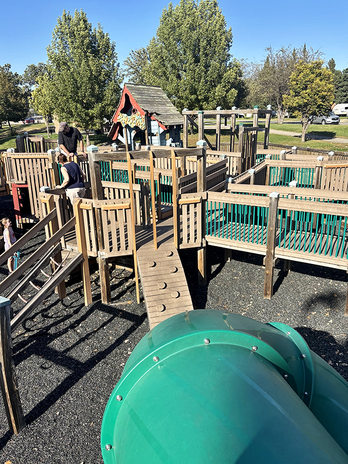 The playground's intricate wooden pathways invite exploration, with each turn revealing new opportunities for discovery.