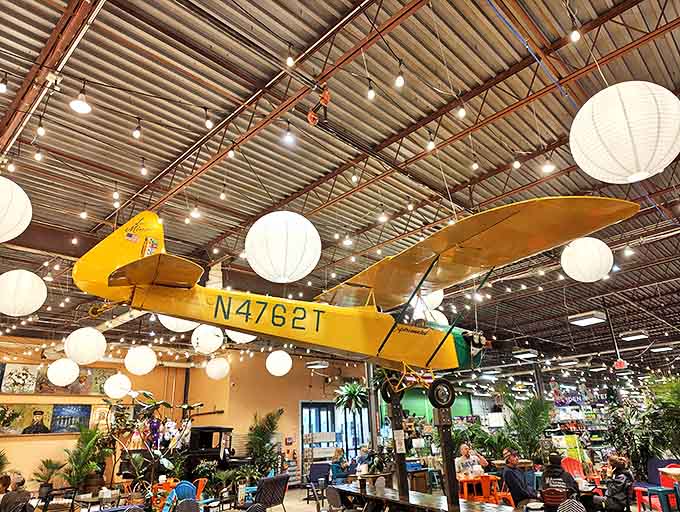 Yes, that's a real vintage yellow airplane hanging from the ceiling, because why shouldn't grocery shopping include aviation history?