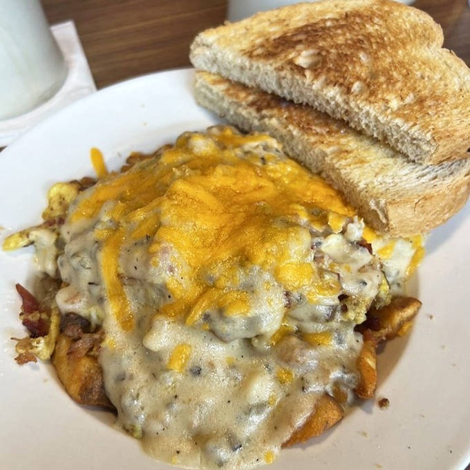 Breakfast poutine that laughs in the face of diet plans. Crispy potatoes, melty cheese, and savory toppings create a morning indulgence worth every delicious calorie.
