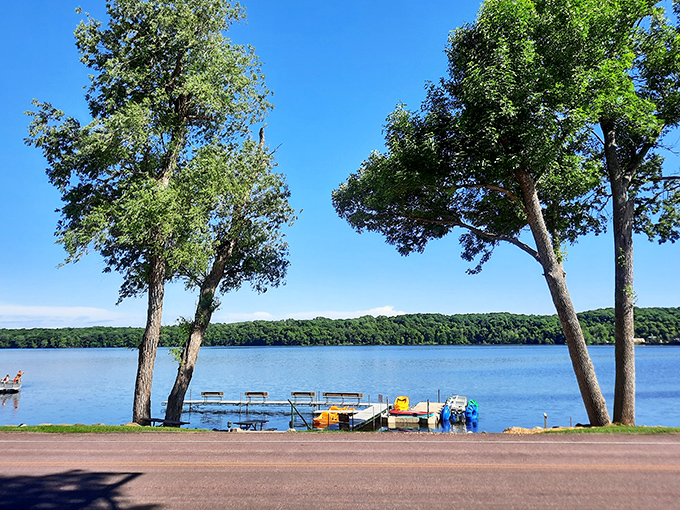 Mother Nature showing off with a postcard-perfect lake scene. Those trees have witnessed generations of "watch this, Mom!" moments from the dock.