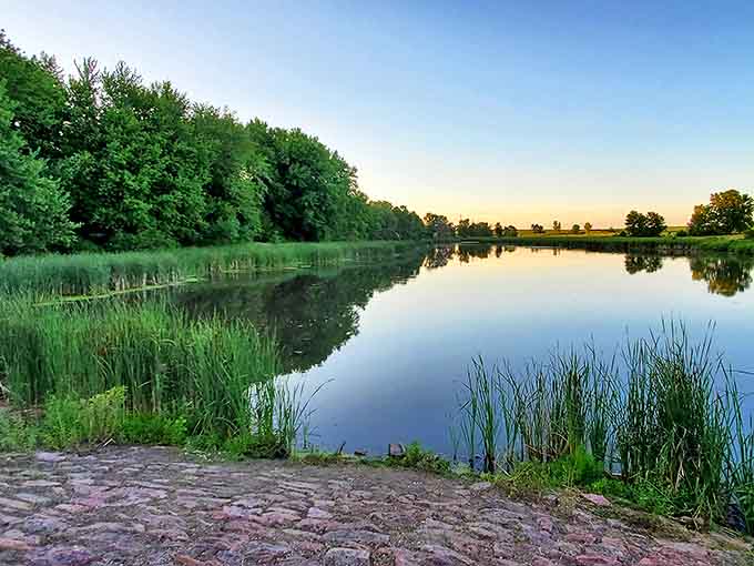 This tranquil lake at dusk serves as nature's mirror, doubling the beauty and giving photographers twice the reason to forget dinner reservations.