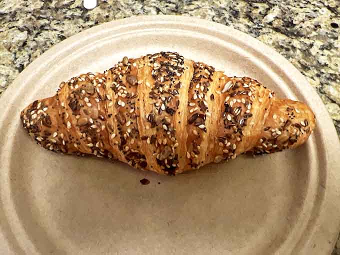 This isn't just a croissant &ndash; it's a butter delivery system disguised as breakfast, wearing seeds like formal attire.