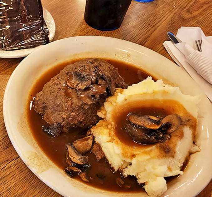 Homestyle meatloaf smothered in mushroom gravy, creating little pools of flavor around cloud-like mashed potatoes &ndash; a midwestern masterpiece.