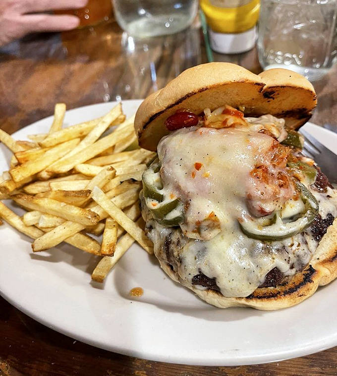Melted cheese drips enticingly down this burger masterpiece, while crispy onion rings stand guard like delicious sentinels.