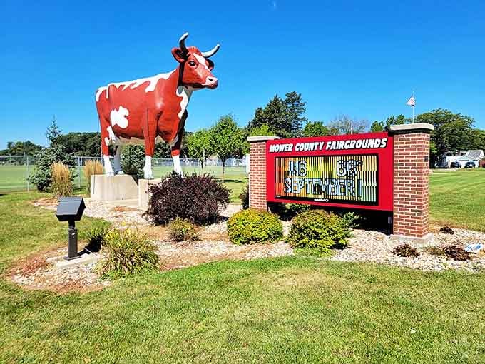 The digital sign board announces upcoming events, while Buffy stands as the fairground's permanent, patient greeter.