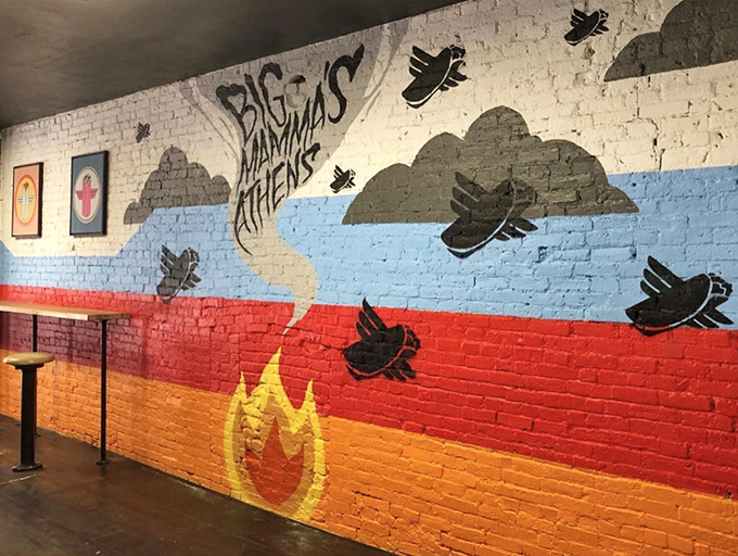 Mural: Vibrant wall art featuring flying burritos against colorful stripes &ndash; like if Warhol and Rivera collaborated on a food-inspired fever dream.