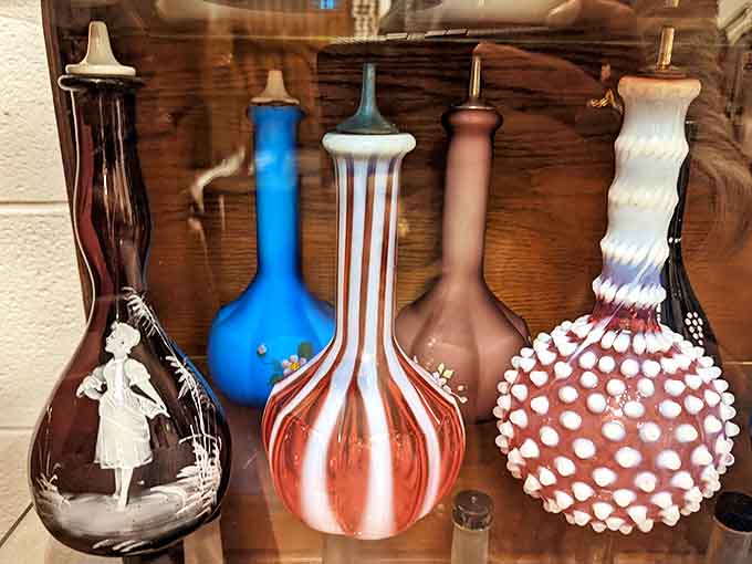 Colorful vintage barber cruets that once held aftershave and tonics now capture the artistic side of grooming history.