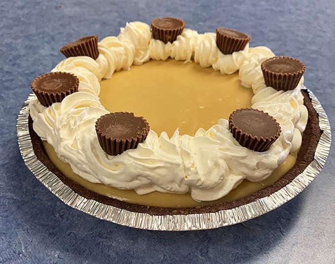 Peanut Butter Cup Pie: Decadence defined &ndash; a chocolate crust cradles creamy peanut butter filling, crowned with whipped cream and Reese's cups.