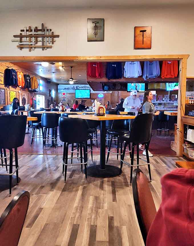 Inside the Rusty Duck Bar & Grill, locals gather around wooden tables to enjoy hearty burgers while gnomes watch from cozy corners.