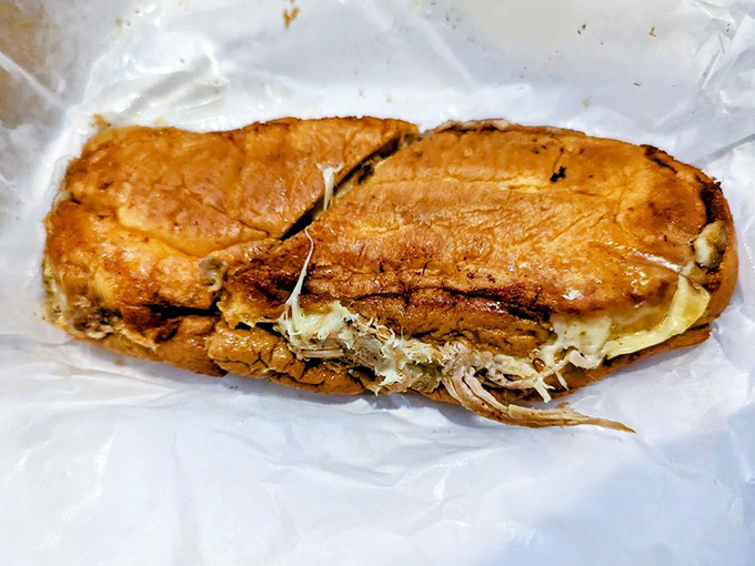 Slow-roasted pork nestled in crusty bread &ndash; each bite releases a symphony of garlic, citrus, and perfectly rendered fat.