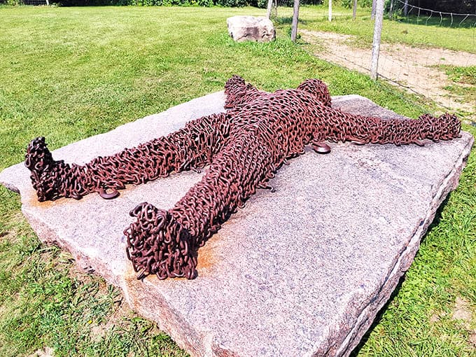 "Chain Man" reclines in metallic comfort, proving that even the most unyielding materials can look surprisingly relaxed in the hands of a skilled artist.