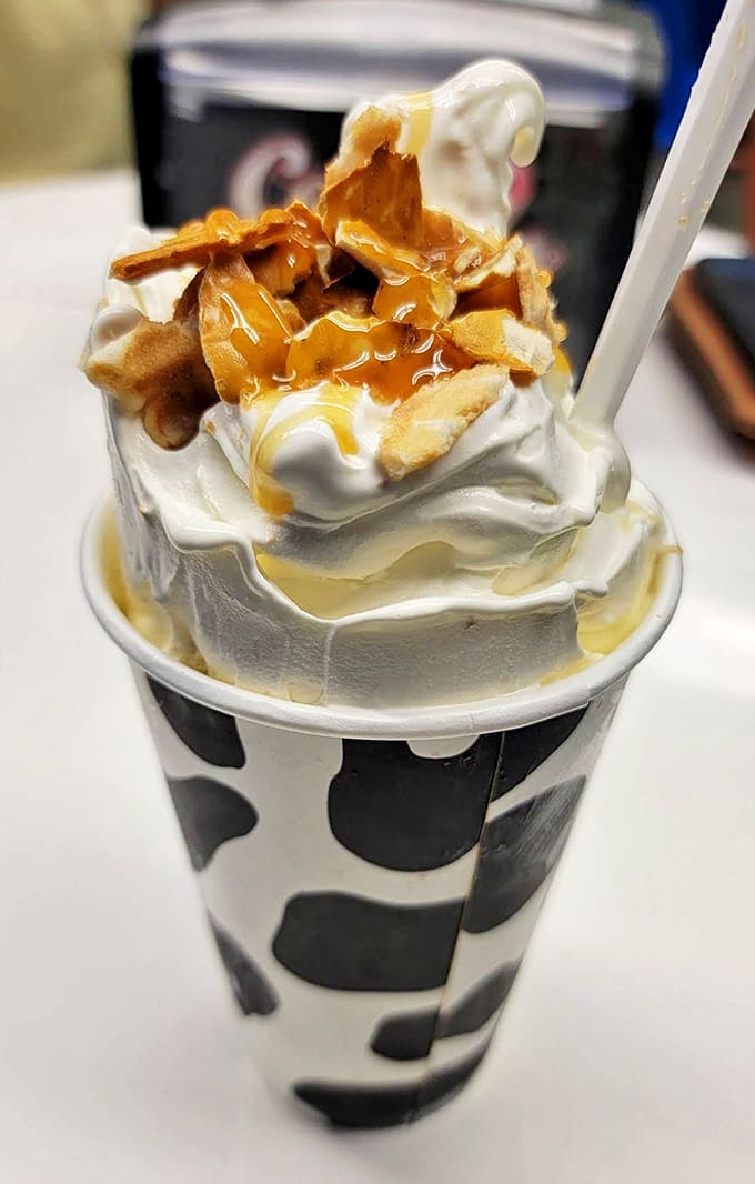 Caramel cascades over vanilla soft serve like a slow-motion waterfall of sweetness, topped with crunchy waffle pieces.
