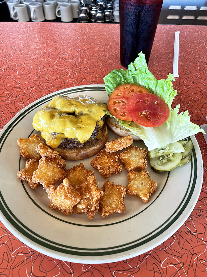 Star-shaped potato nuggets add a playful touch to a perfectly melted cheeseburger &ndash; proof that sometimes the sides deserve equal billing with the main attraction.