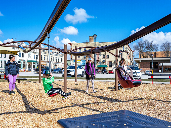 The community playground buzzes with laughter and energy &ndash; where local families have gathered for generations.
