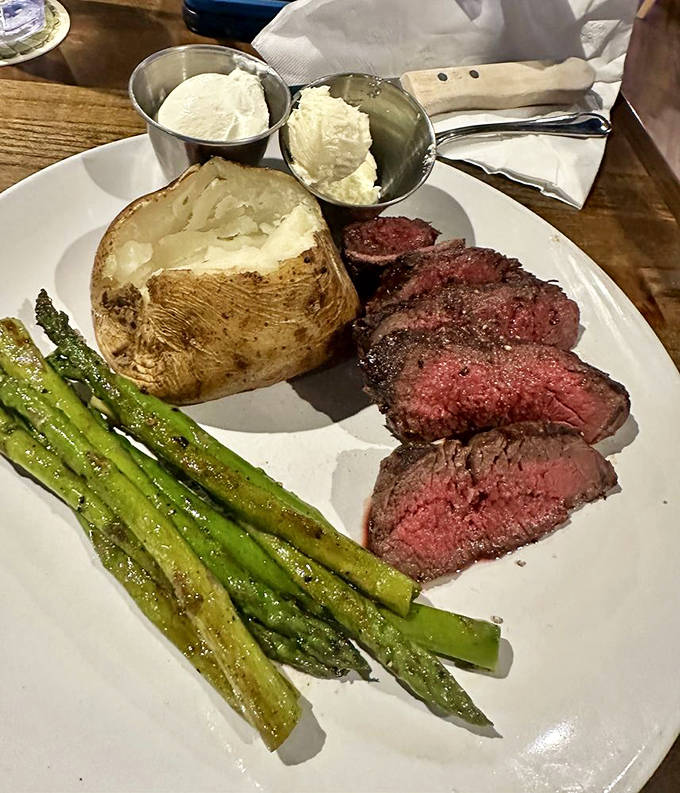 A perfectly cooked steak alongside asparagus and a loaded baked potato&mdash;proof that sometimes the classics are classics for a very good reason.
