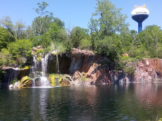 Sunlight plays across the falls, highlighting the remarkable red-orange hue that makes Montello granite famous throughout the Midwest.
