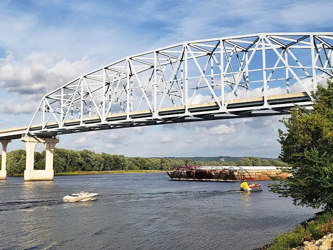 The Wabasha-Nelson Bridge stretches across the mighty Mississippi like a steel spine, connecting two states while boats glide beneath its impressive spans.
