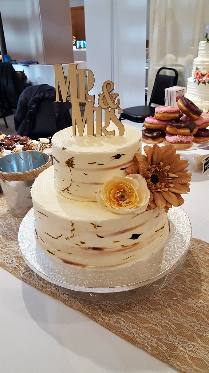 Wedding cake elegance with rustic birch-inspired frosting, proving small-town bakeries can create big-city sophistication.