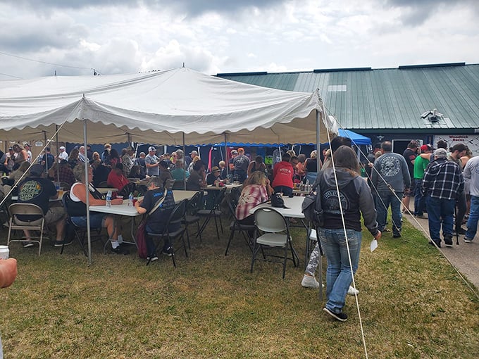 The outdoor gathering area transforms for special events, with tents sheltering patrons from summer sun or unexpected rain showers.