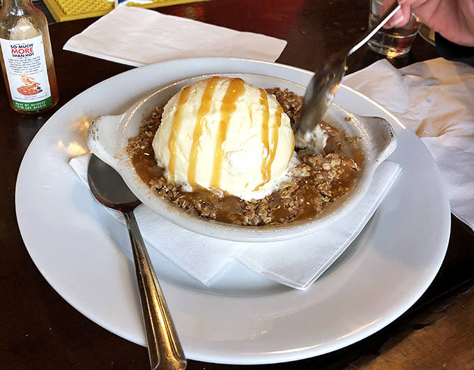 Sweet endings don't get better than this warm apple crumble topped with melting vanilla ice cream – a perfect finale to your railroad dining adventure.