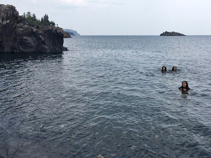 The beach's unique black sand creates an otherworldly canvas where footprints become temporary art installations erased by each incoming wave.