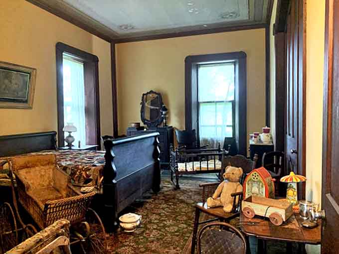 This bedroom and nursery space offers a touching glimpse into family life at Mac-A-Cheek, complete with antique toys that children once treasured.