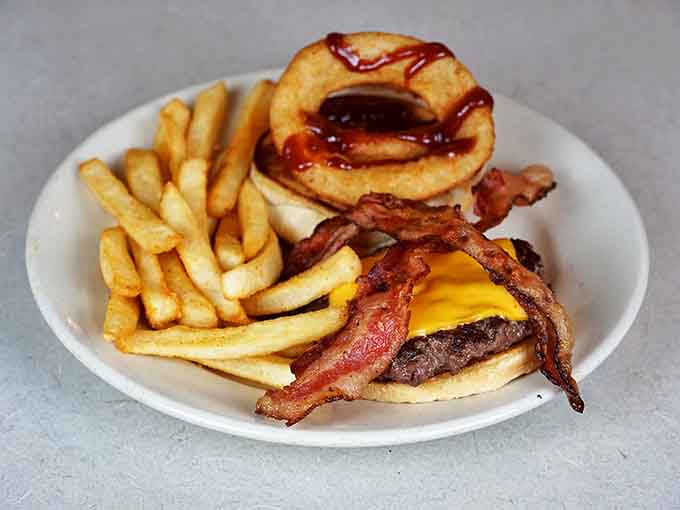 The burger that launched a thousand napkins: juicy patty, melty cheese, crispy bacon, and an onion ring hat that demands respect.