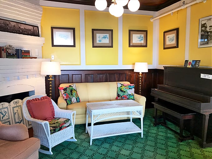 Green carpet meets yellow walls in this sitting area, where the piano silently waits for the next guest brave enough to play "Heart and Soul."