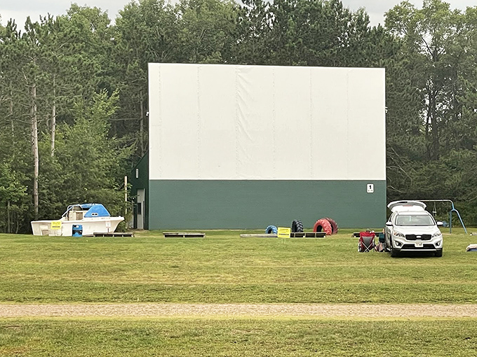 The massive screen dominates the clearing, a beacon of entertainment in the northwoods setting.