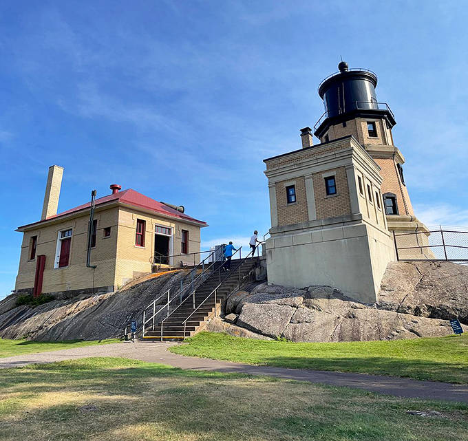 The lighthouse entryway welcomes visitors with its classic brick construction. Those stairs have witnessed decades of keepers climbing to maintain the vital beacon above.