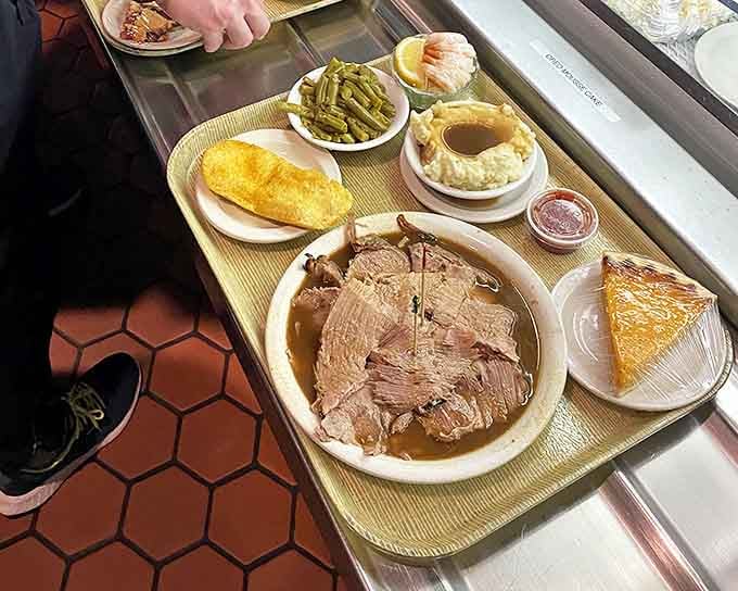 A perfectly balanced tray of comfort &ndash; roast beef swimming in gravy, green beans, mashed potatoes, and pie waiting in the wings.