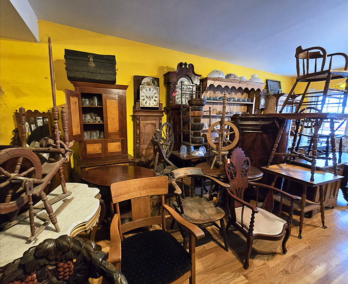 A yellow room bursting with wooden treasures – rocking chairs, grandfather clocks, and spinning wheels waiting for someone to bring them home.